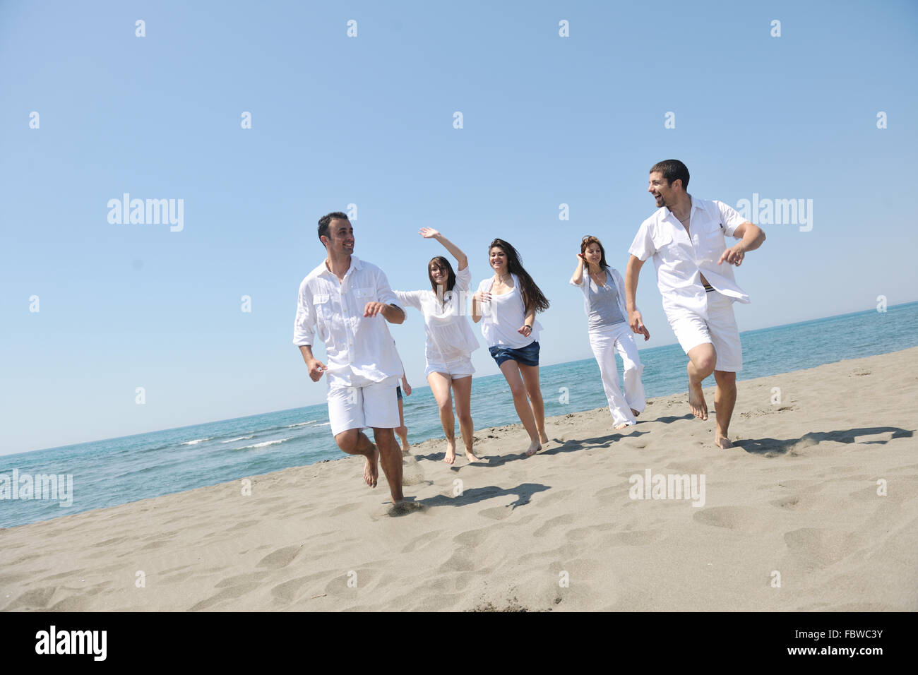 happy people group have fun and running on beach Stock Photo - Alamy