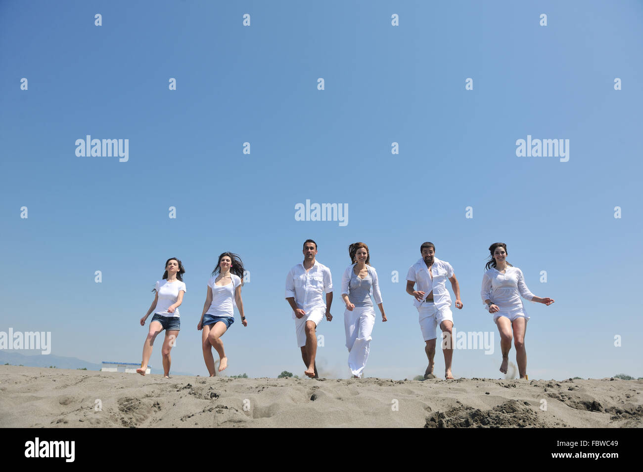 happy people group have fun and running on beach Stock Photo - Alamy