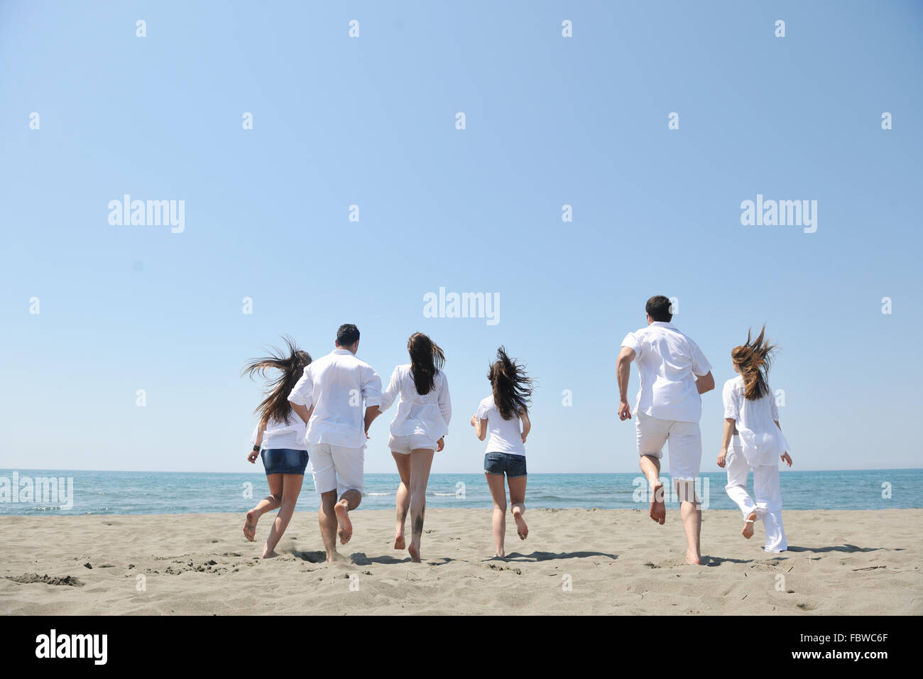happy people group have fun and running on beach Stock Photo - Alamy