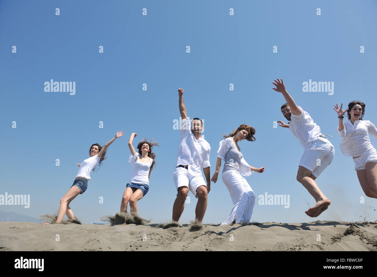 happy people group have fun and running on beach Stock Photo - Alamy