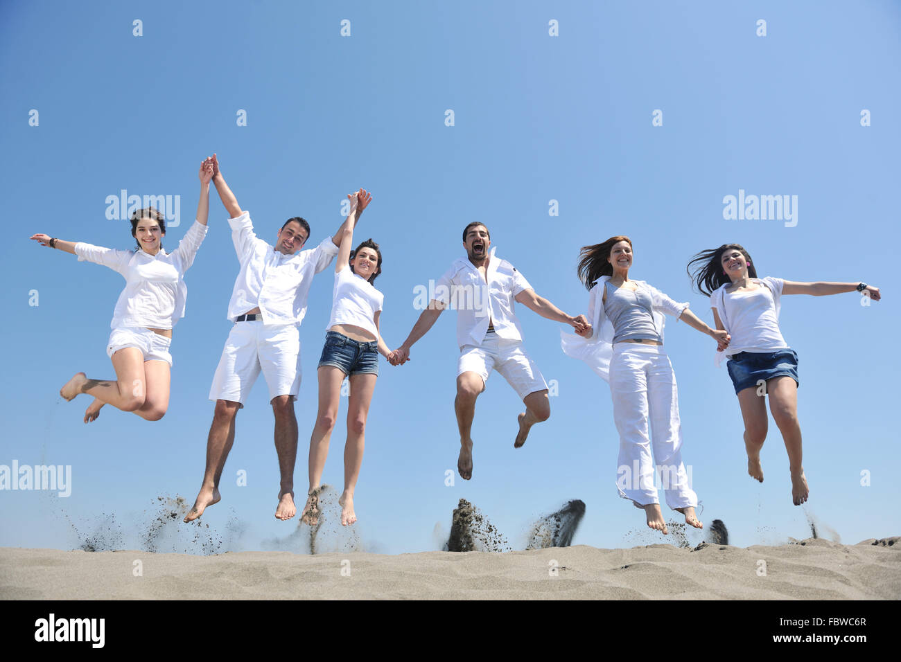 happy people group have fun and running on beach Stock Photo - Alamy