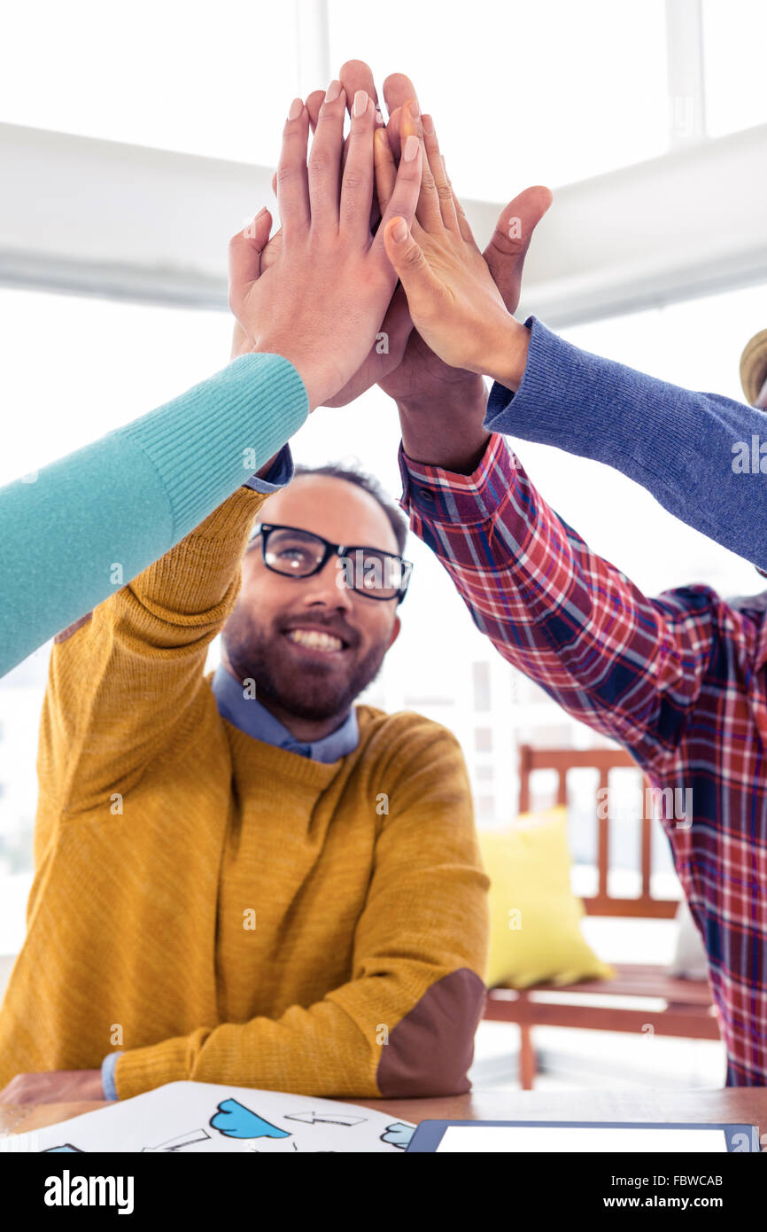 Business man doing high five with team in creative office Stock Photo ...
