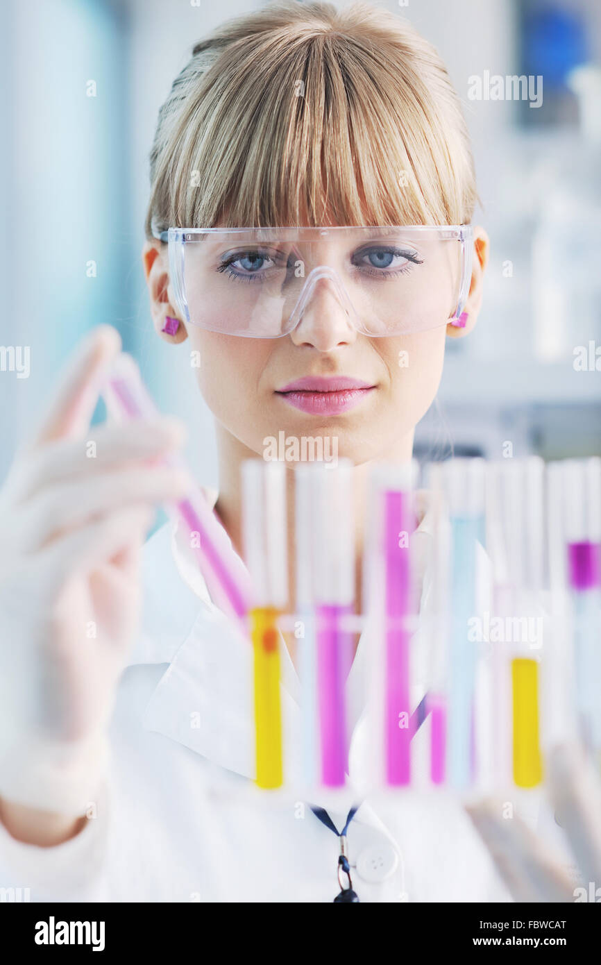 female researcher holding up a test tube in lab Stock Photo - Alamy