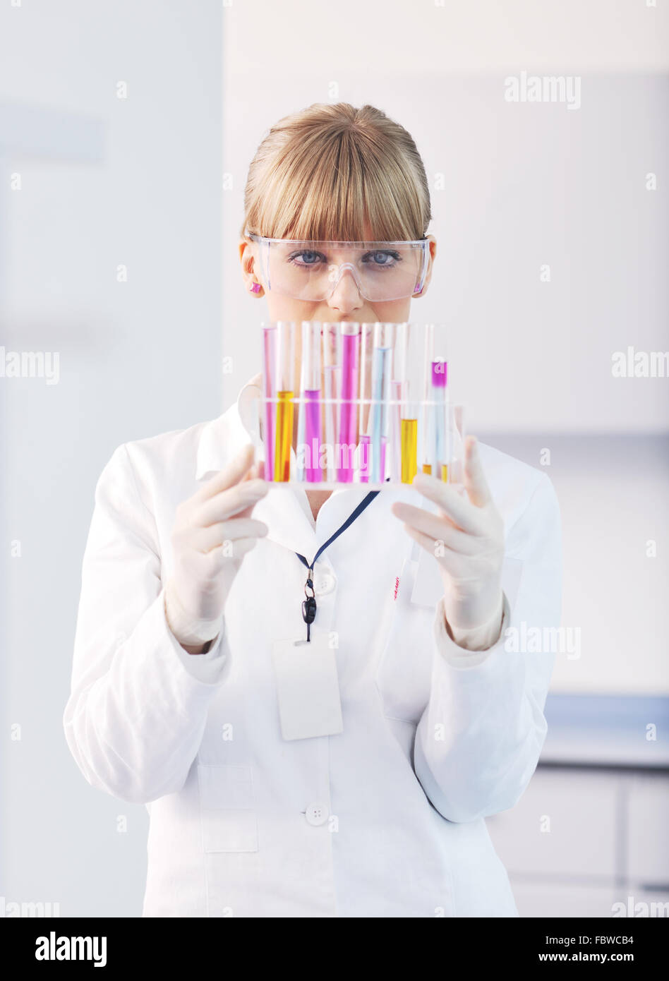 female researcher holding up a test tube in lab Stock Photo - Alamy