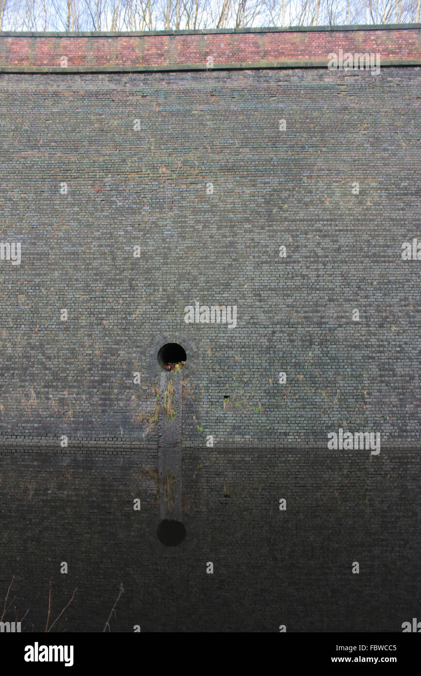 A culvert hole in The Great Wall of Todmorden. The massive brick wall ...