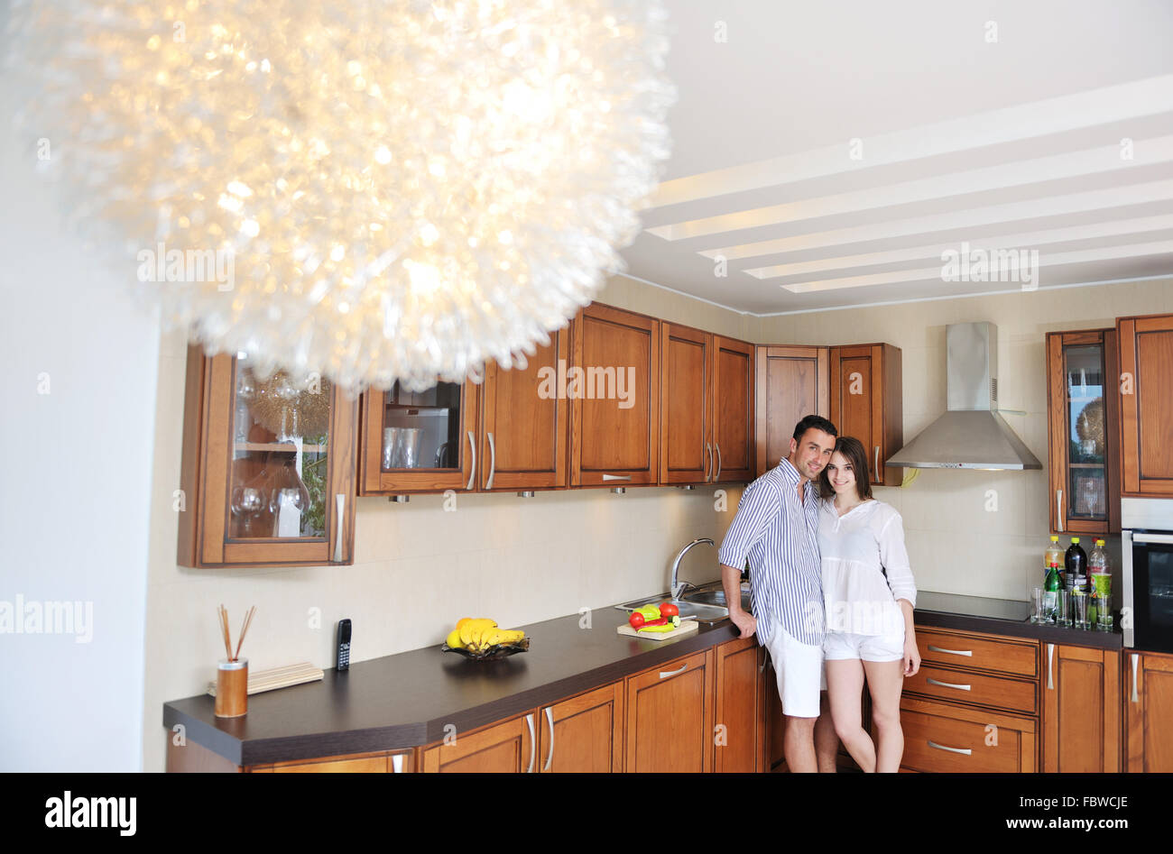 happy young couple have fun in modern kitchen Stock Photo - Alamy