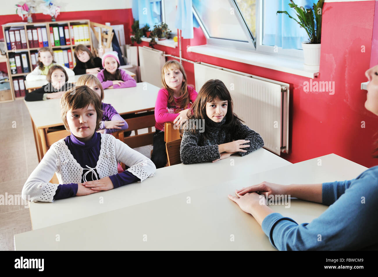 happy kids with teacher in school classroom Stock Photo - Alamy