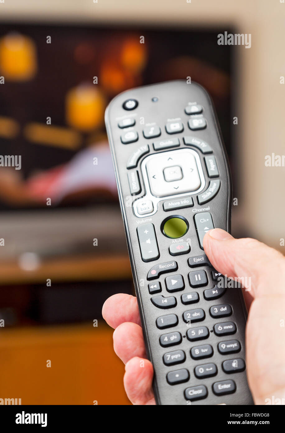 Close up of TV remote control with television Stock Photo - Alamy