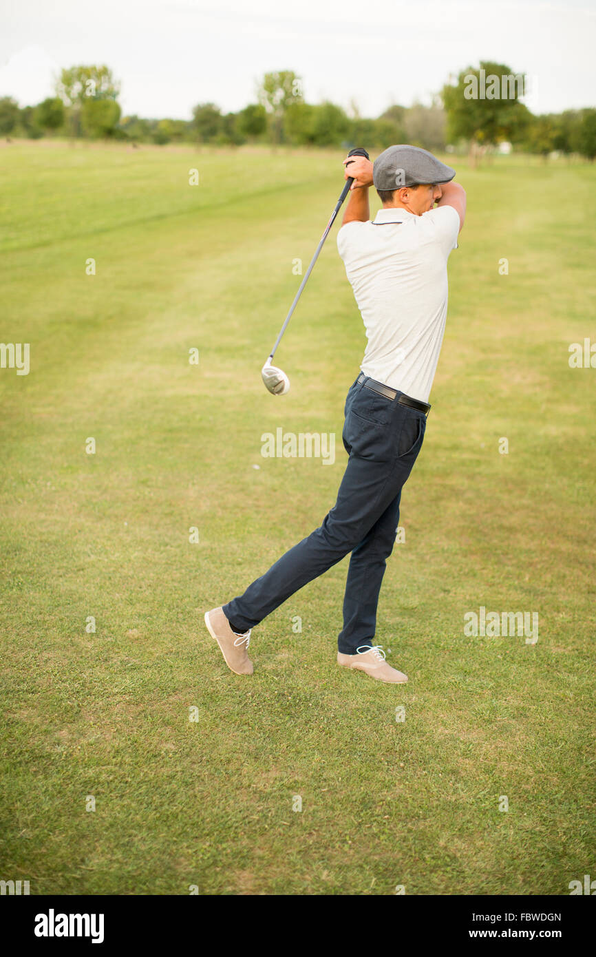 Young man playing golf Stock Photo - Alamy