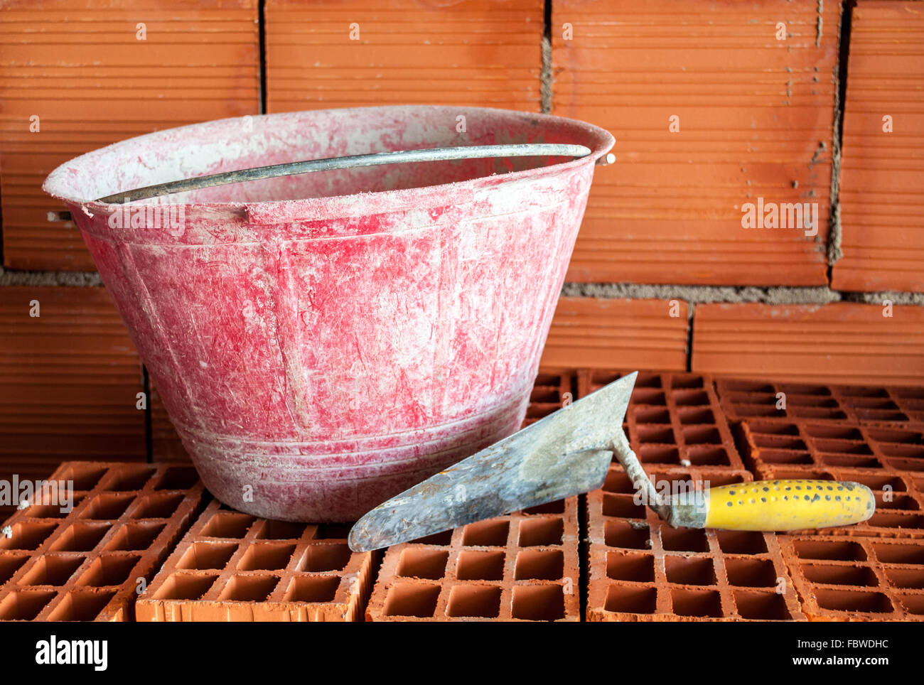 Trowel, bucket and bricks Stock Photo - Alamy