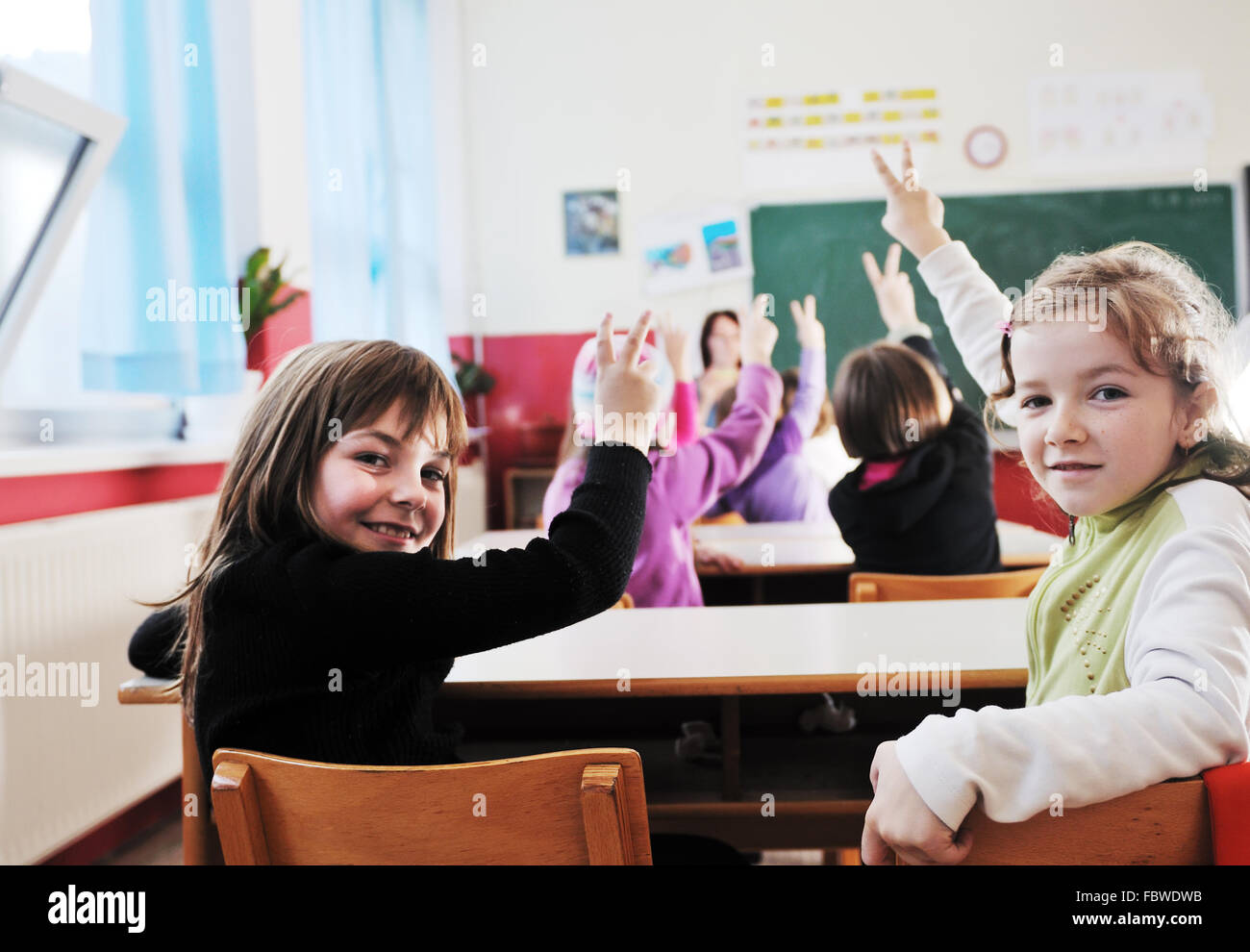 happy kids with teacher in school classroom Stock Photo - Alamy