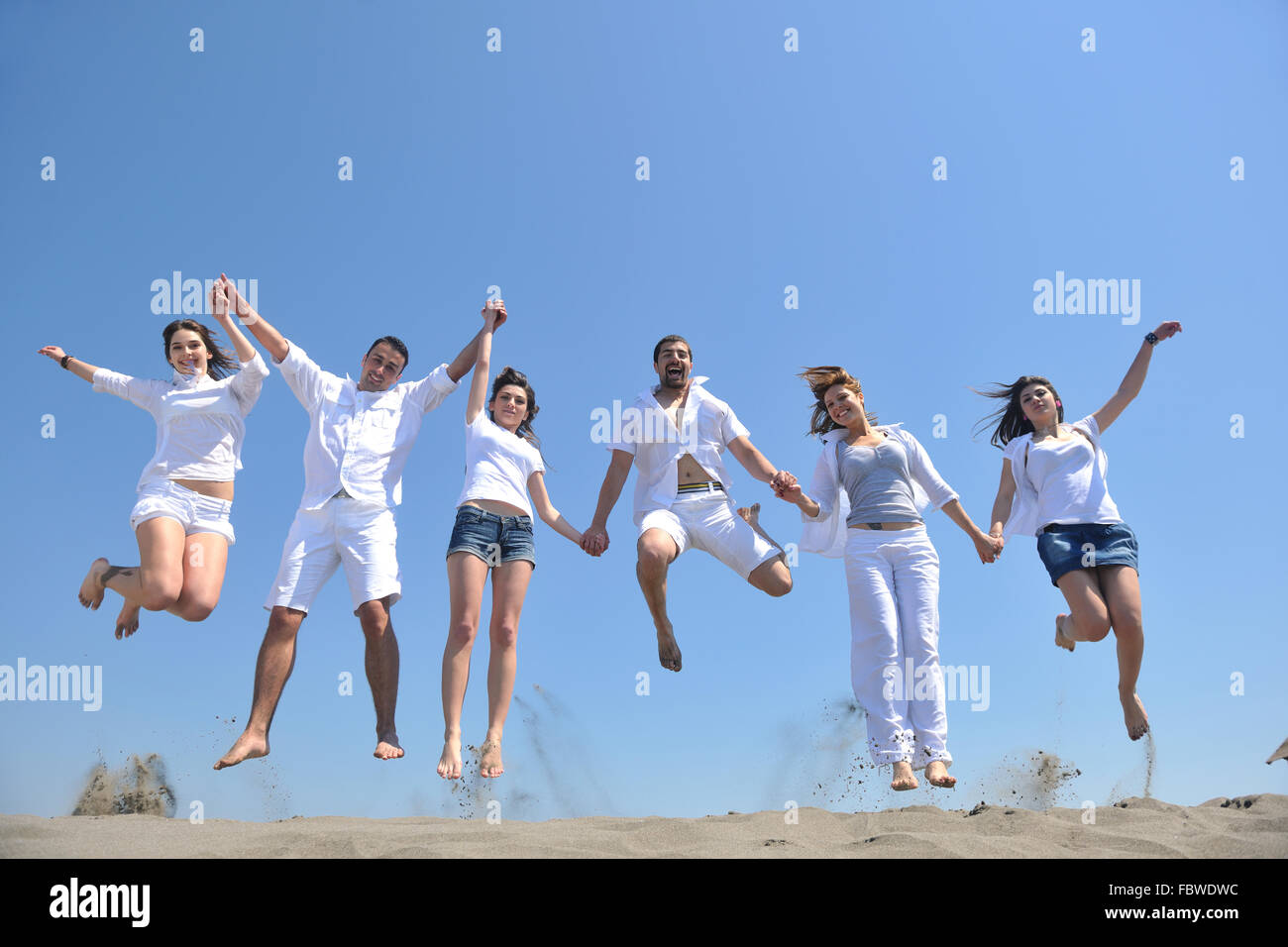 happy people group have fun and running on beach Stock Photo - Alamy