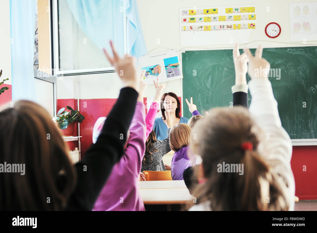 happy kids with teacher in school classroom Stock Photo - Alamy