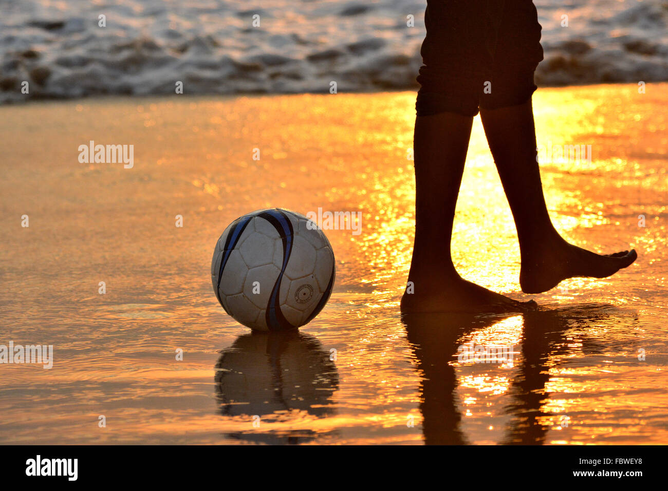 football by the side of feet Stock Photo - Alamy
