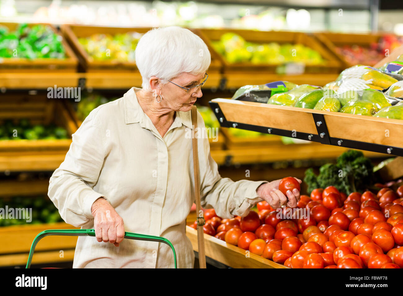 Senior woman picking out some vegetables Stock Photo - Alamy