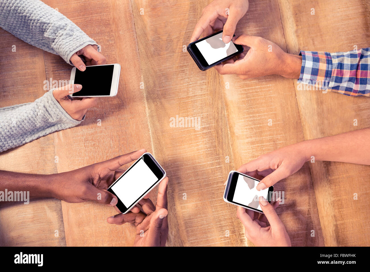 Business people using smartphones at desk Stock Photo - Alamy