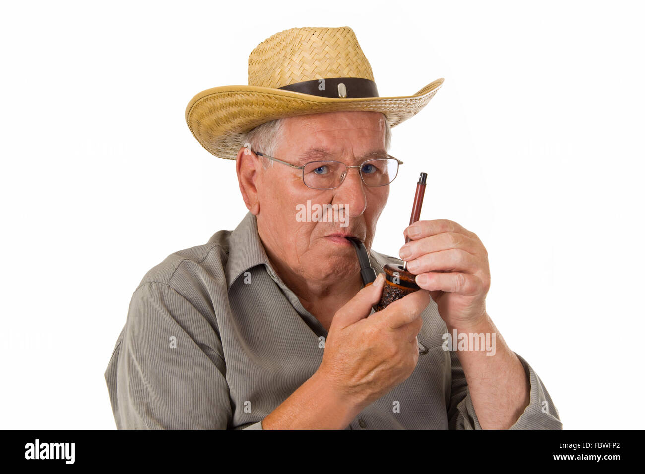 Old man lighting up a pipe Stock Photo - Alamy