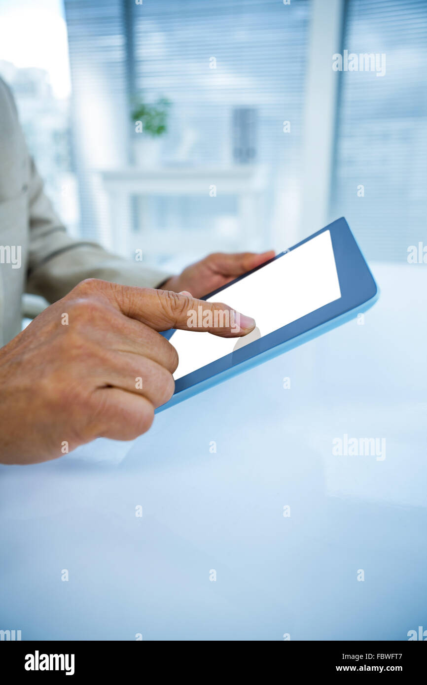 Focused businessman using tablet Stock Photo - Alamy