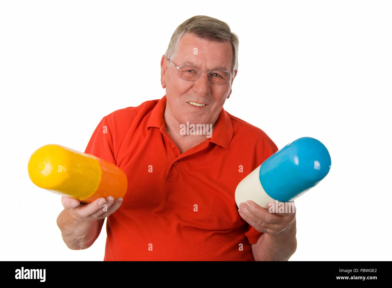 Old man holding big pills Stock Photo - Alamy