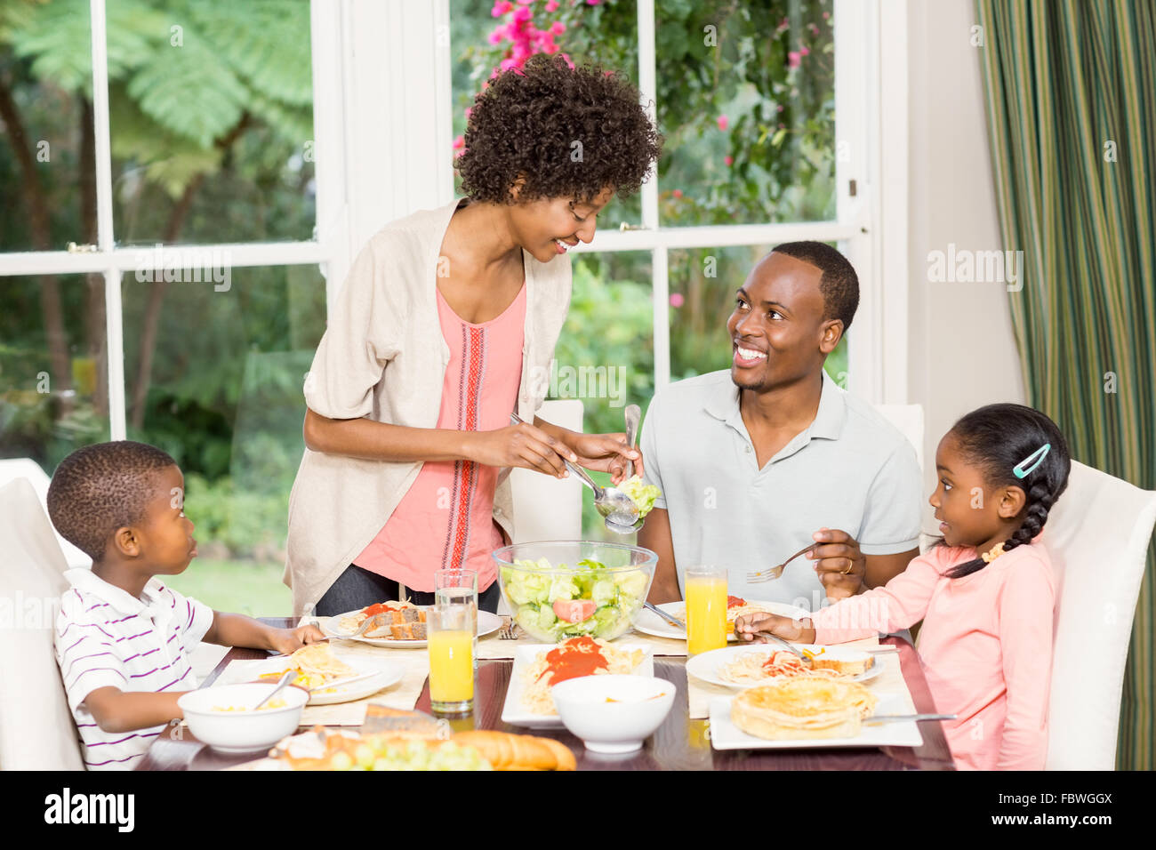 Happy family enjoying their meal Stock Photo - Alamy