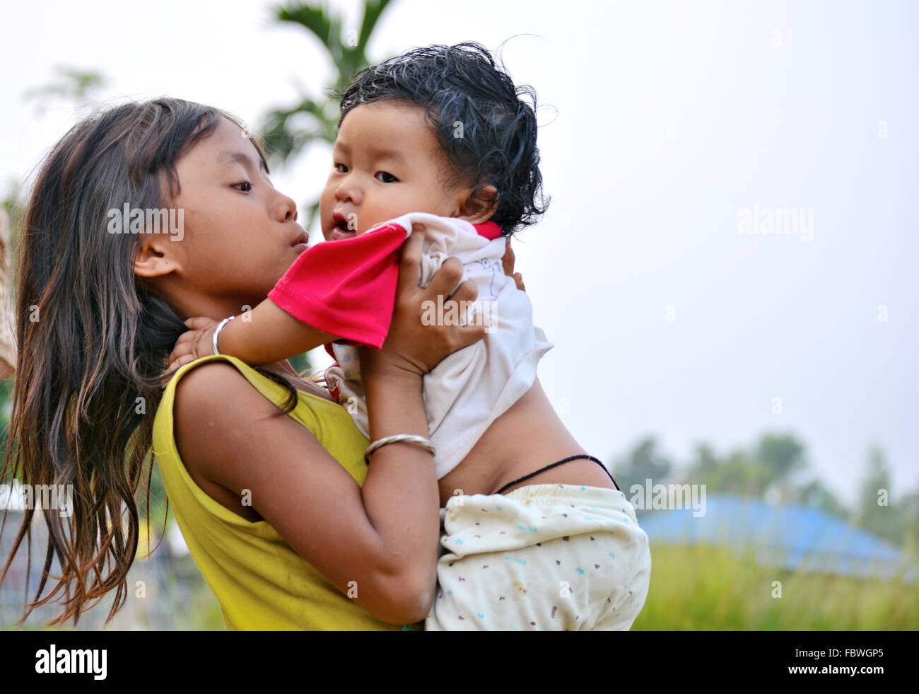 An elder sister carrying her younger brother Stock Photo - Alamy An elder sister carrying her younger brother Stock Photo - Alamy