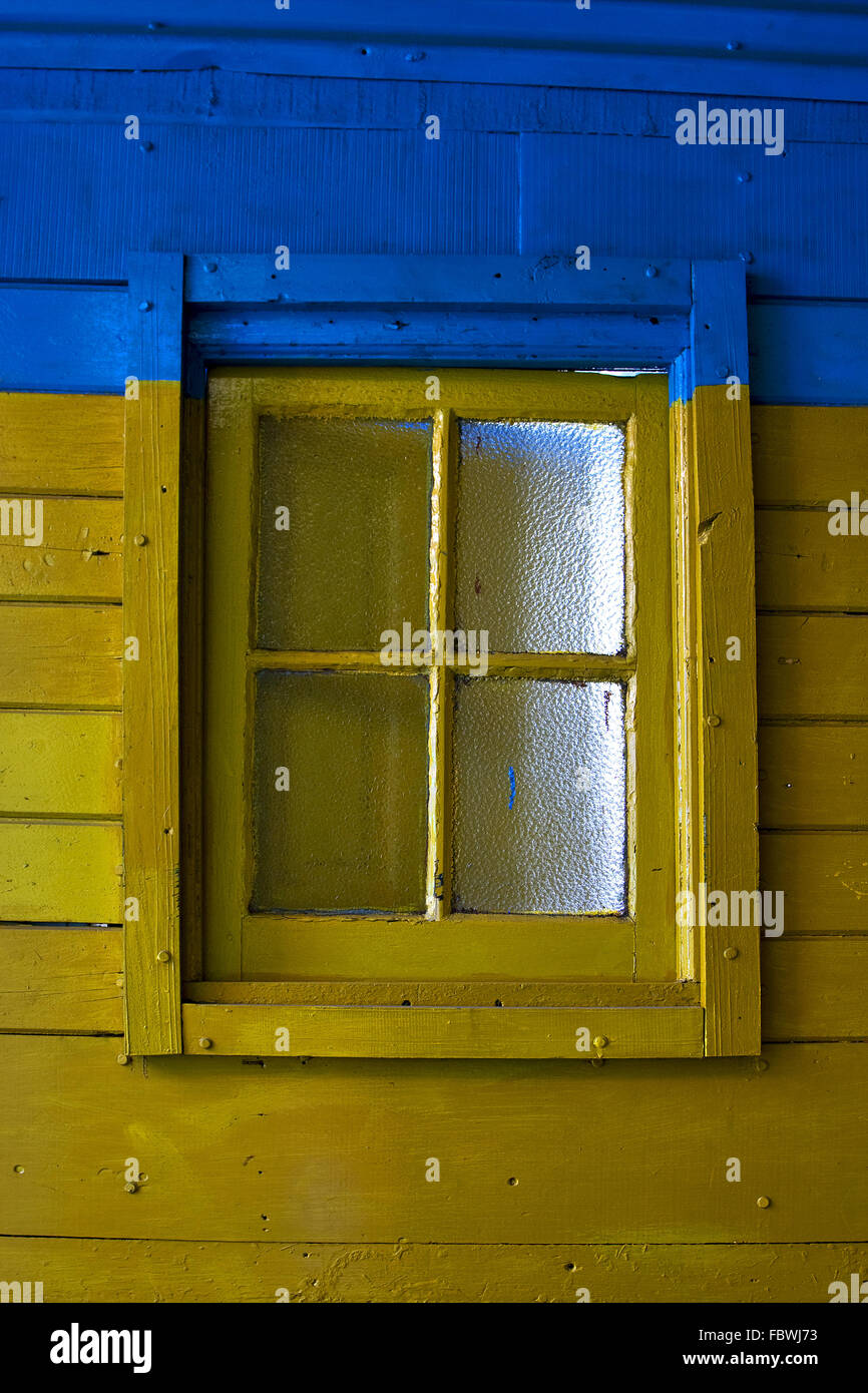 old yellow window in blue wall Stock Photo - Alamy