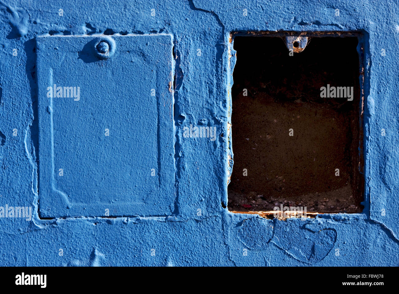 two metal box and a blue wa Stock Photo - Alamy