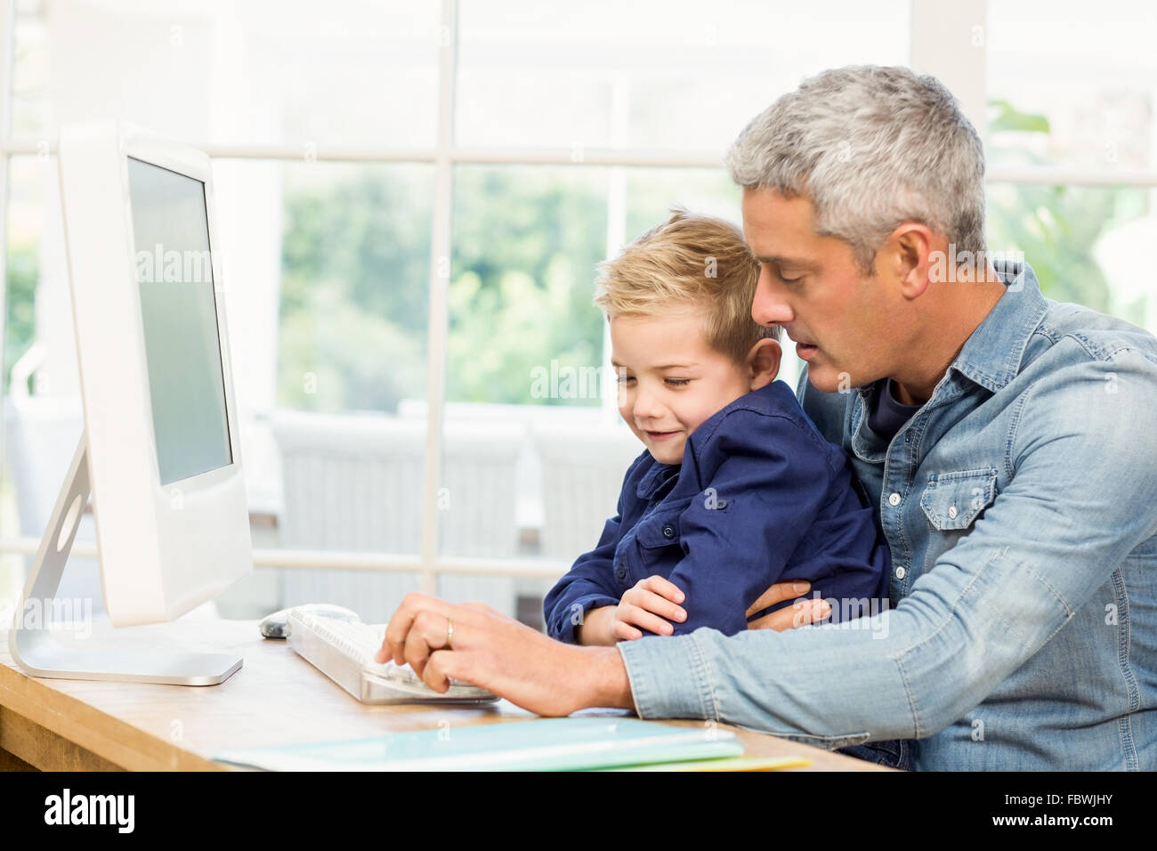 Father and son using the computer Stock Photo - Alamy