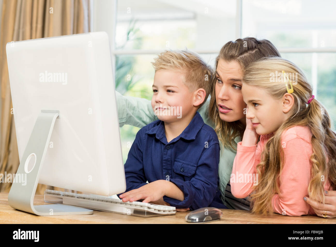 Happy family using the computer Stock Photo - Alamy
