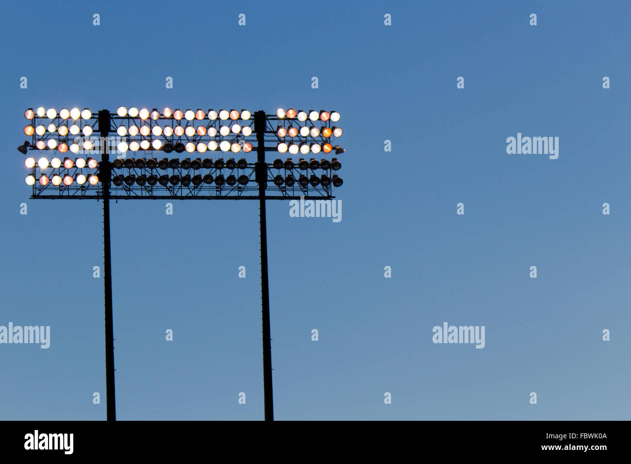 Stadium lights over a blue sky Stock Photo - Alamy
