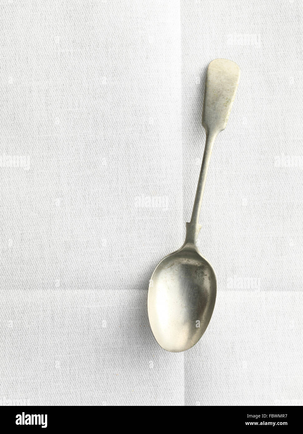 old spoon on linen table cloth with creases Stock Photo - Alamy