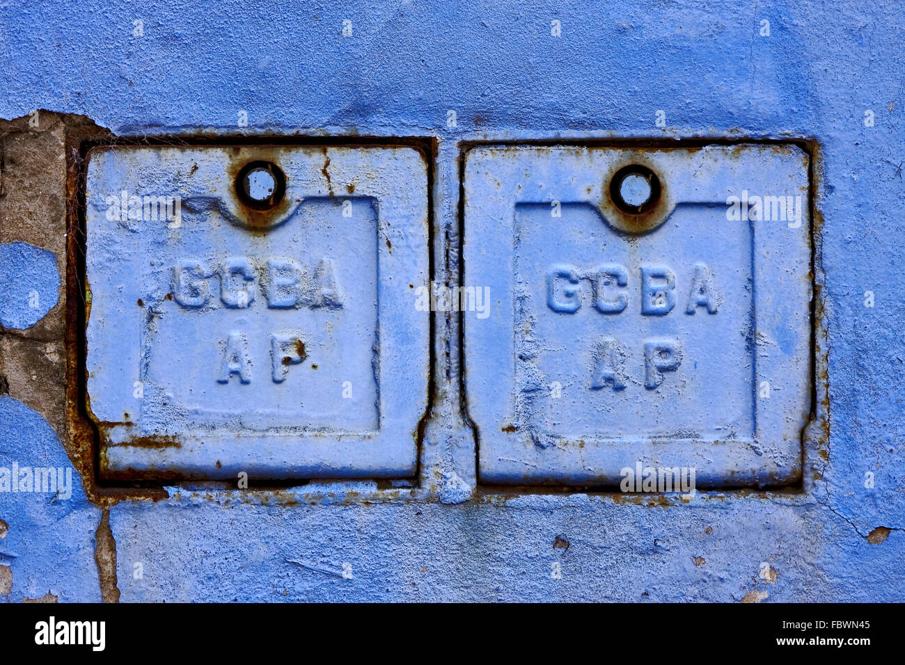 two metal box and a blue broken wall Stock Photo - Alamy