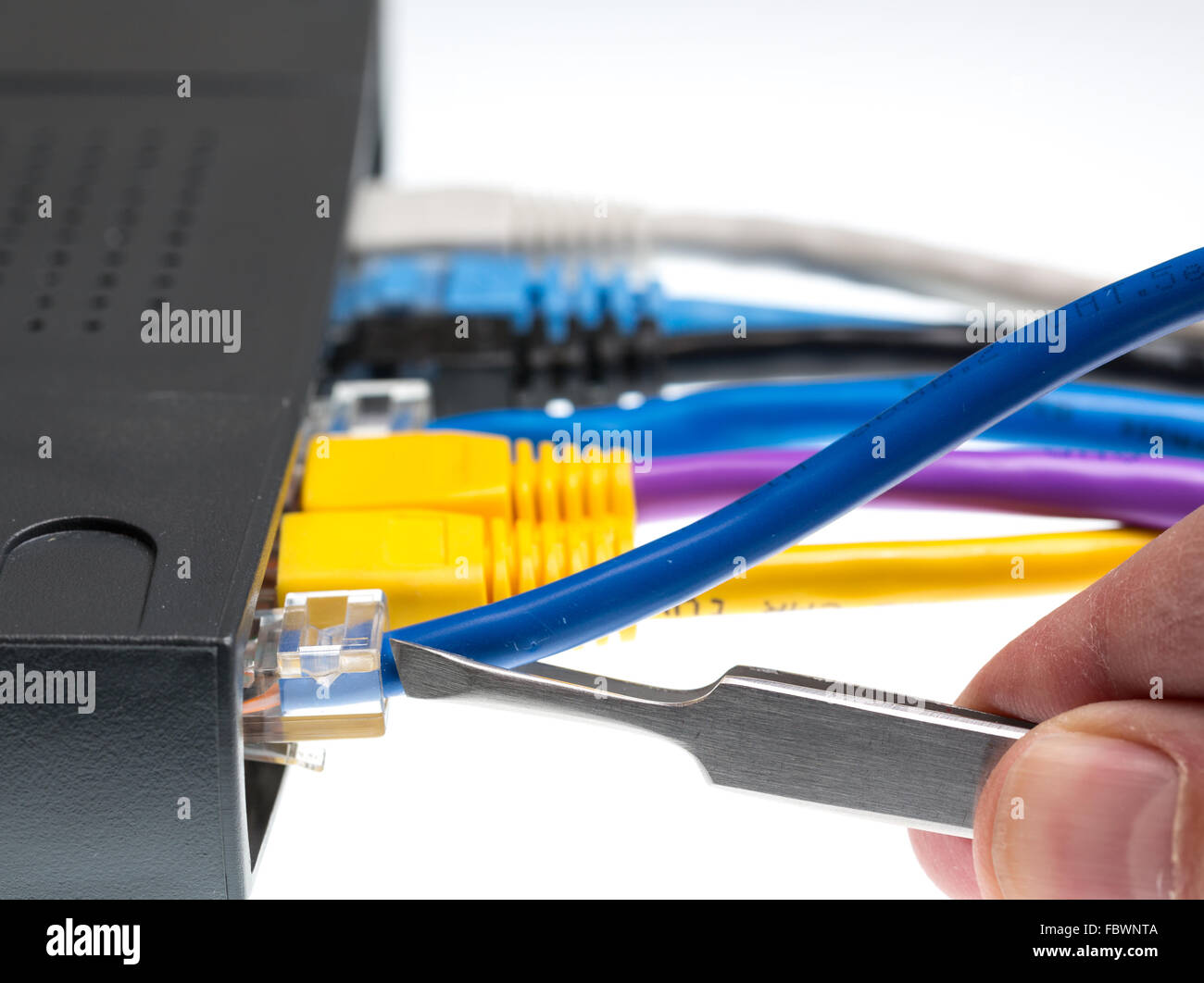 Hand plugs ethernet cable into router hi-res stock photography and ...