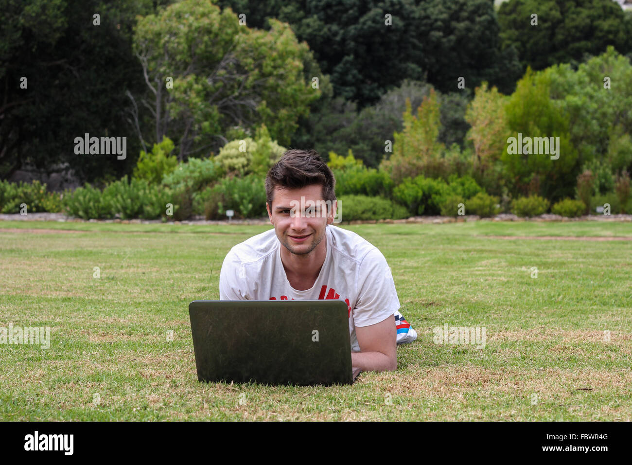 Man working on Notebook outdoors Stock Photo - Alamy