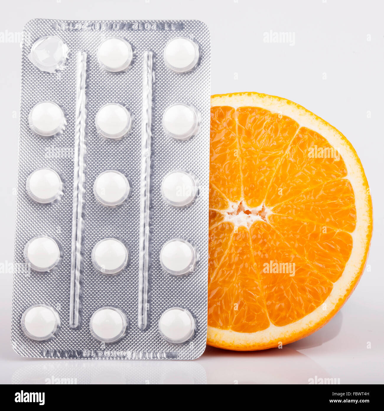 orange and pills on white Stock Photo - Alamy