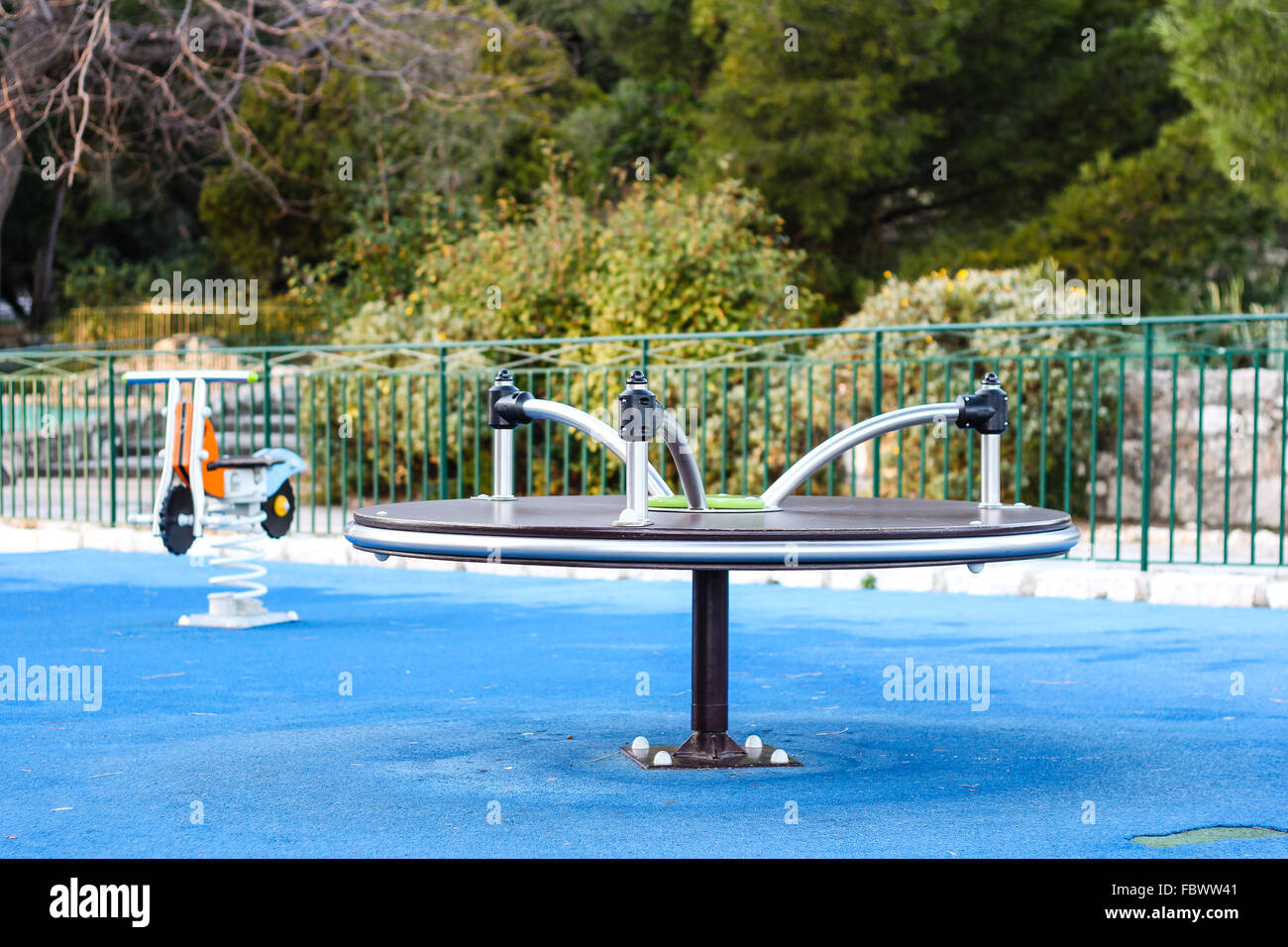 A Carousel At A Playground Stock Photo - Alamy