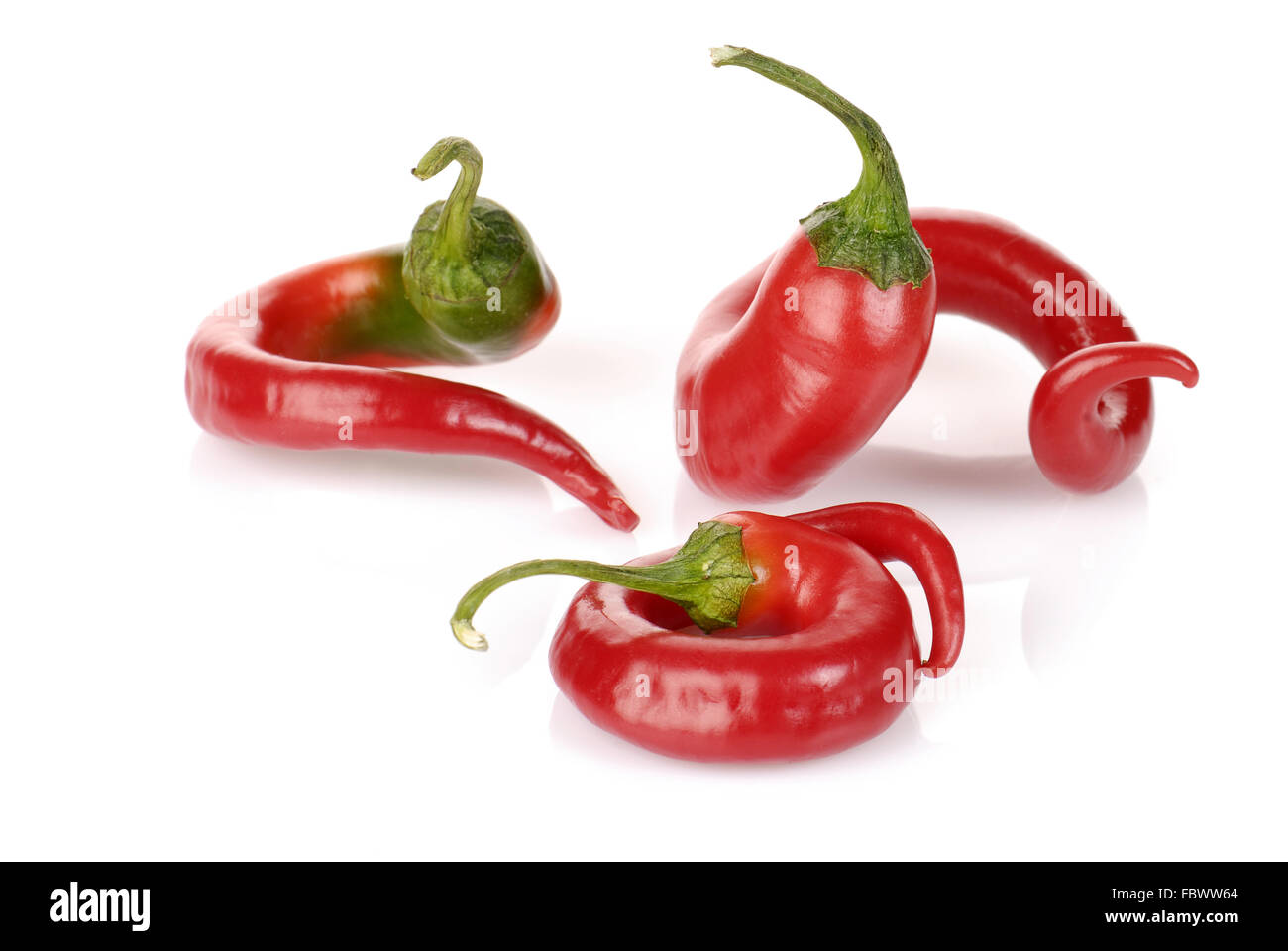curved red chilli peppers isolated on white Stock Photo - Alamy