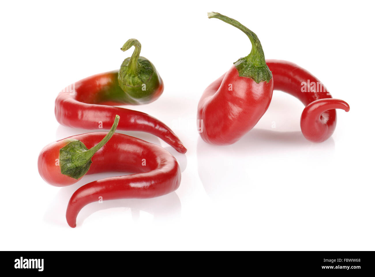 curved red chilli peppers isolated on white Stock Photo - Alamy