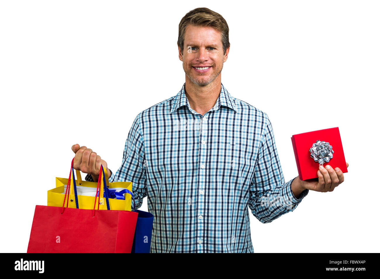 Happy man holding shopping bags and gift box Stock Photo - Alamy