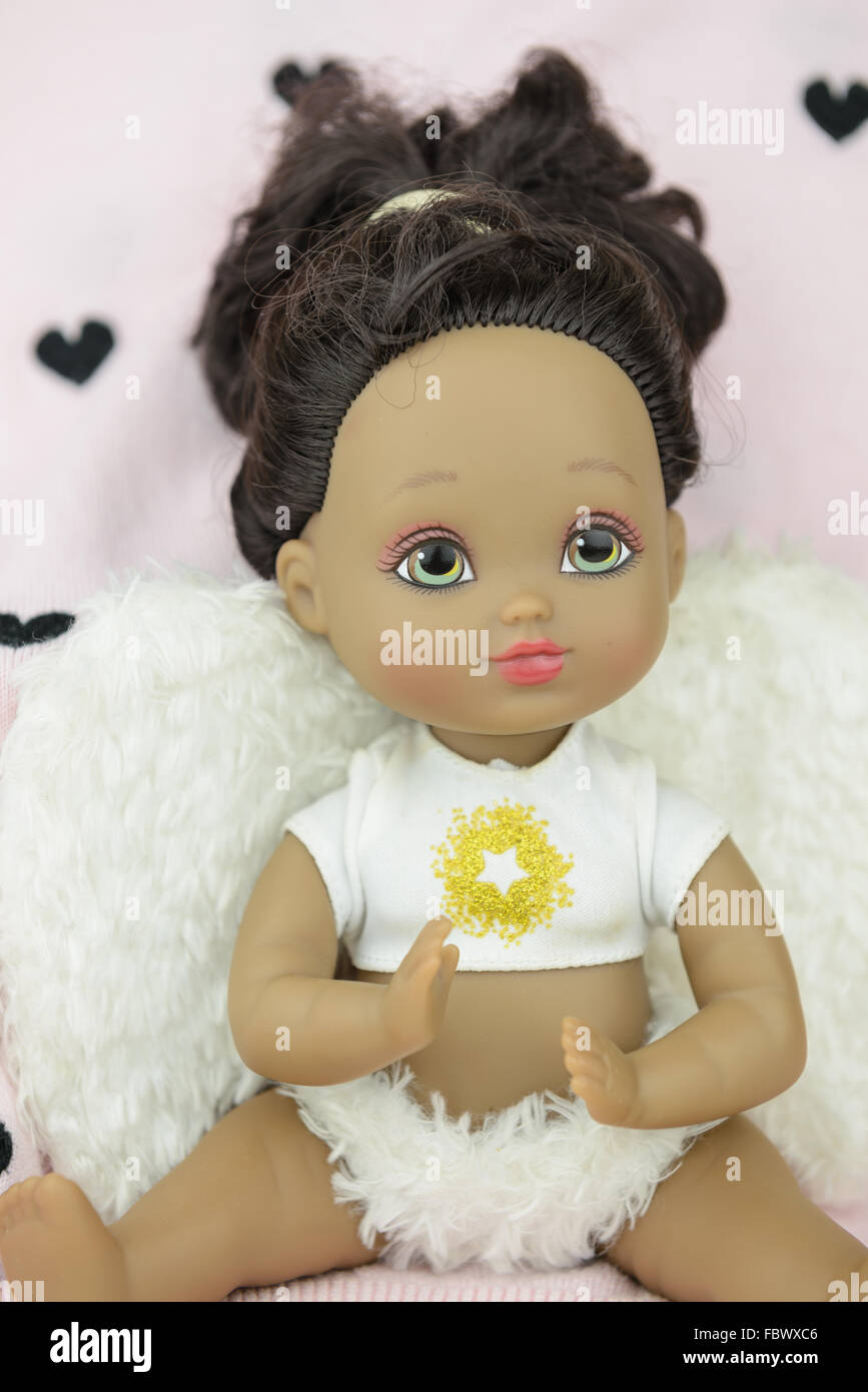 black, tan, skin tone doll in angle suit, white wings, girl Stock Photo ...