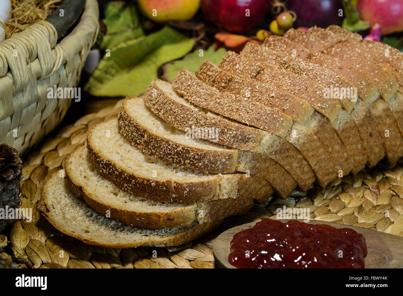 brown whole grain sliced bread with butter and jam, still life, close ...