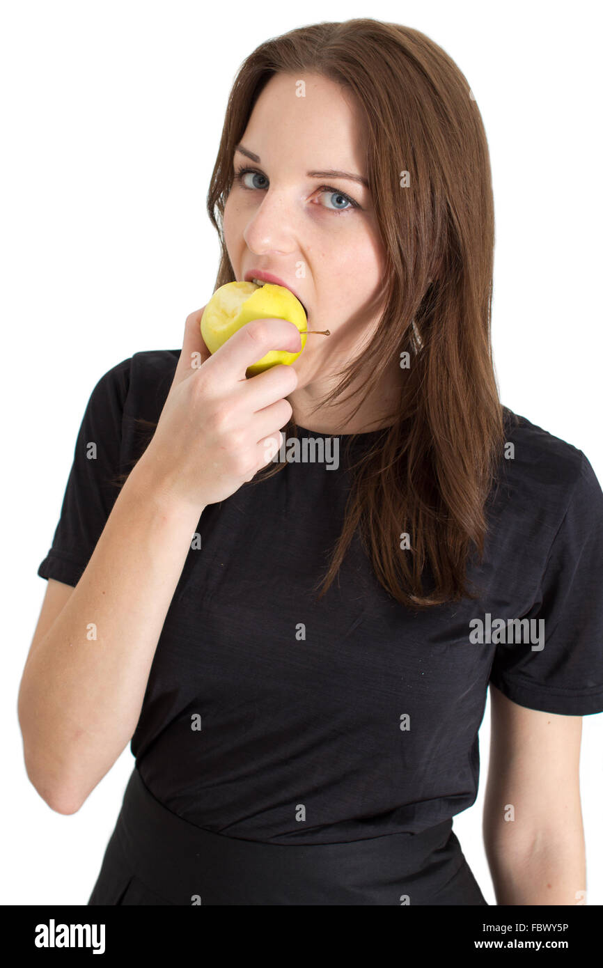 Woman Biting A Yellow Apple Stock Photo - Alamy