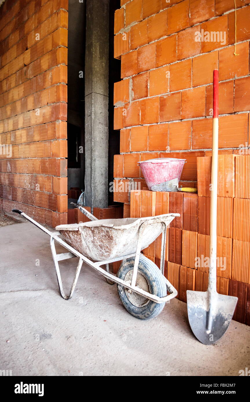 masonry, wheelbarrow, bricks and shovel Stock Photo - Alamy