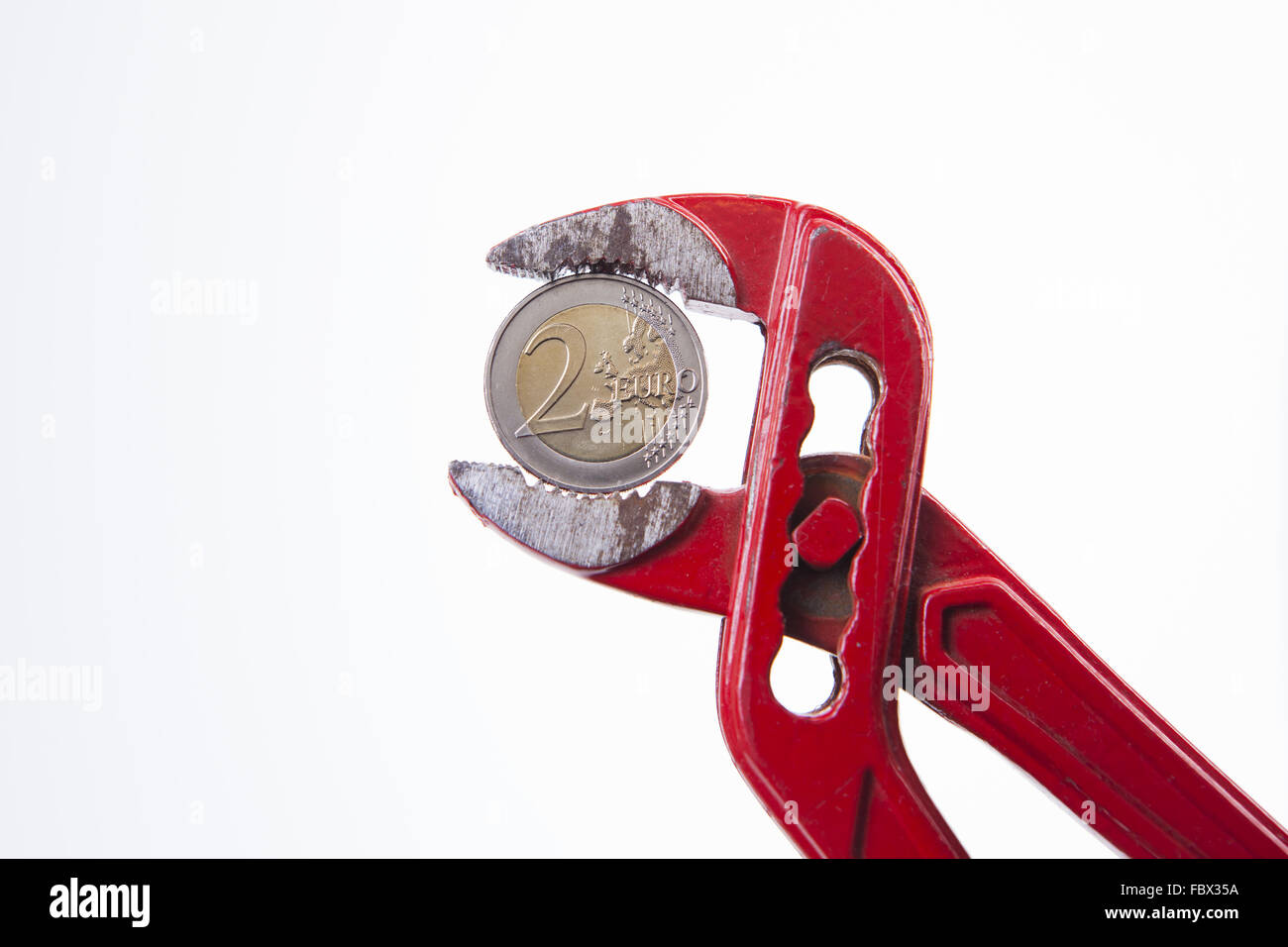Euro coin with gripper Stock Photo - Alamy