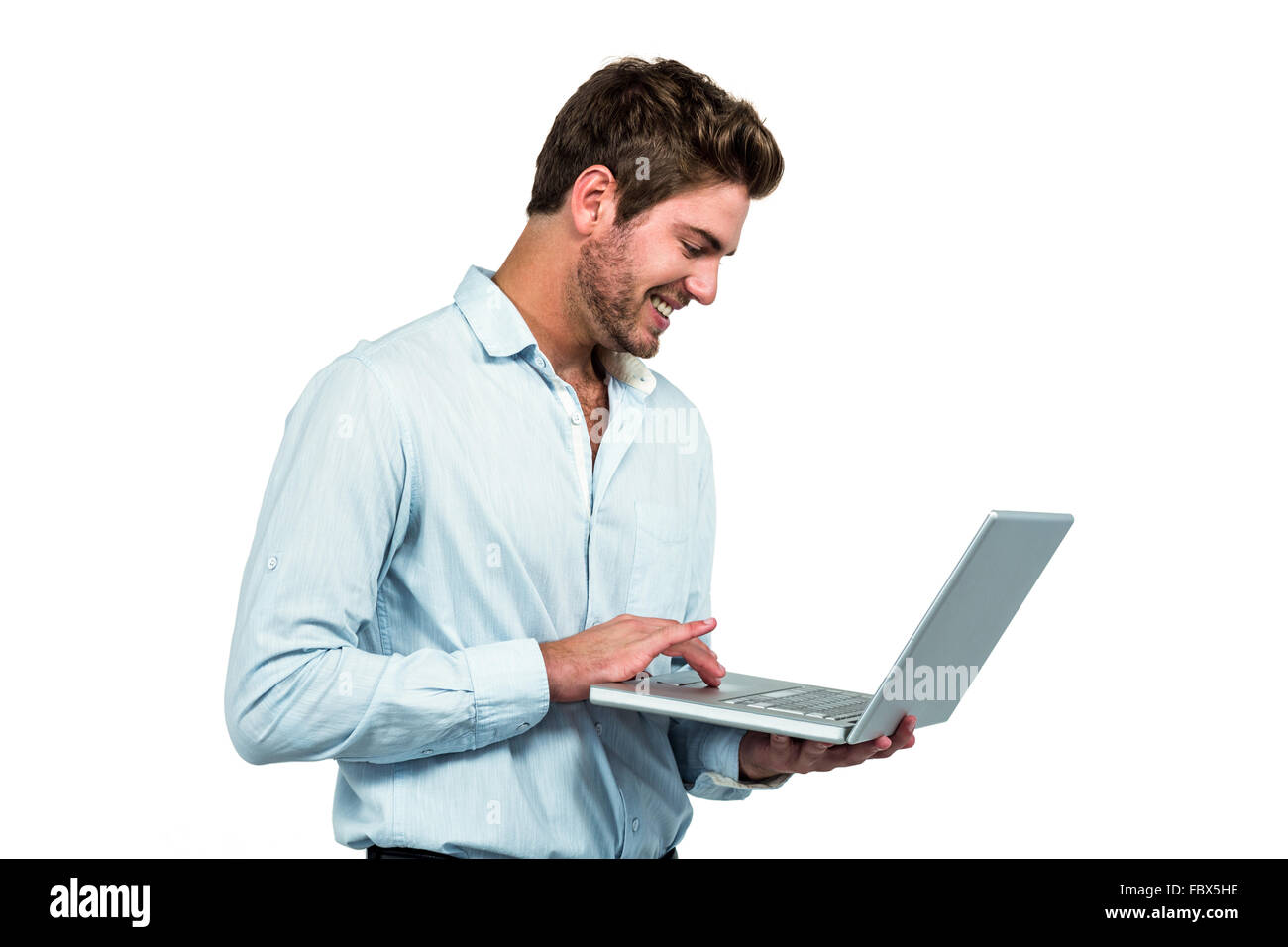 Smiling man using laptop Stock Photo - Alamy