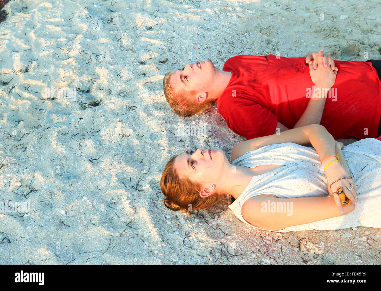 Girl lying on sand hi-res stock photography and images - Alamy