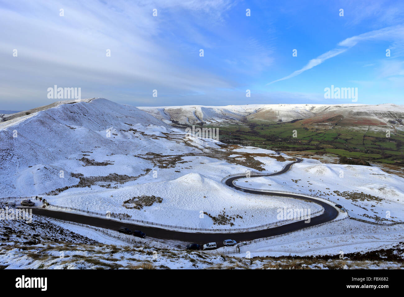 Winding road to Edale below snowy Mam Tor and Rushup Edge near ...