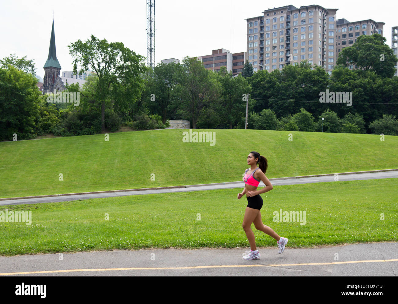 Fit woman running in the city park Stock Photo - Alamy