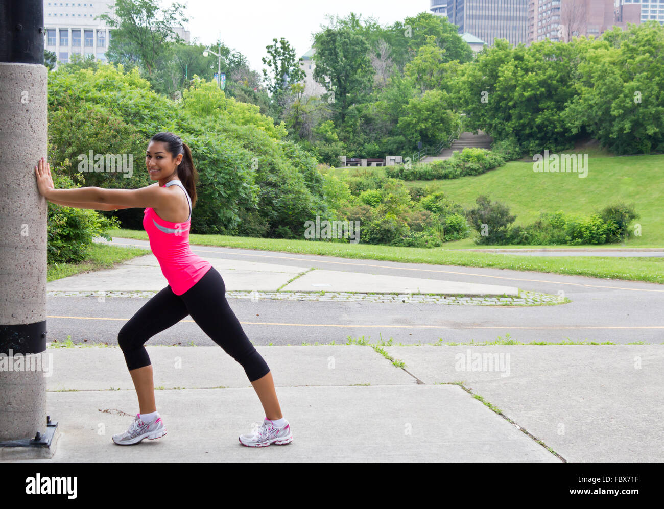 Young woman stretches before running Stock Photo - Alamy