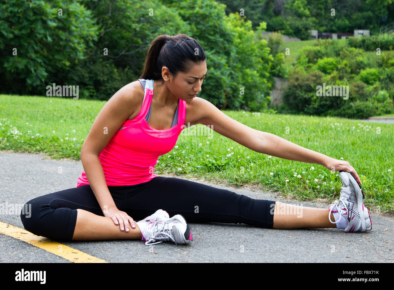 Young woman stretches before running Stock Photo - Alamy